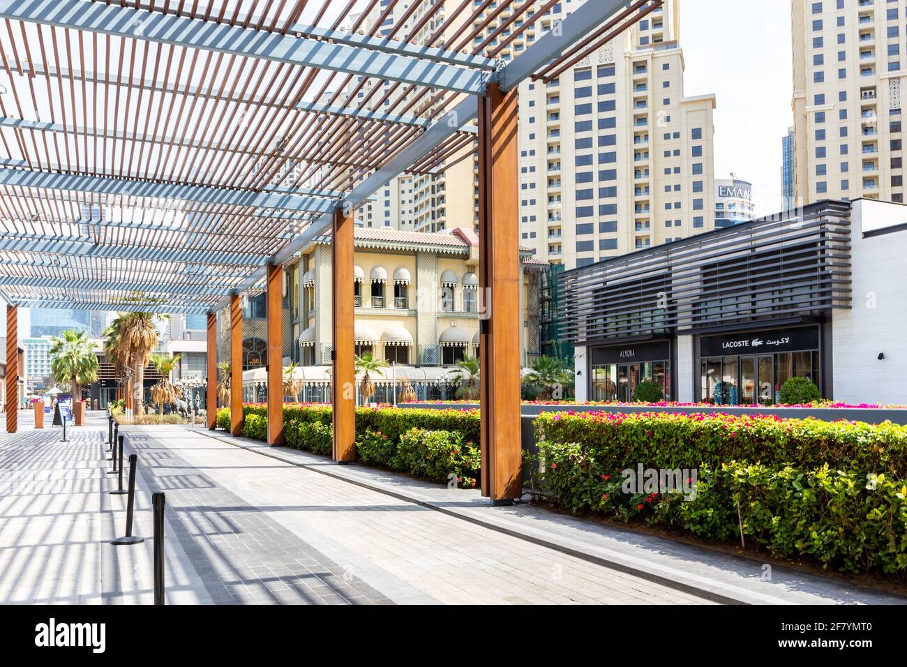 Dubai, UAE, 22.02.2021. Marina The Walk promenade with modern wooden ...