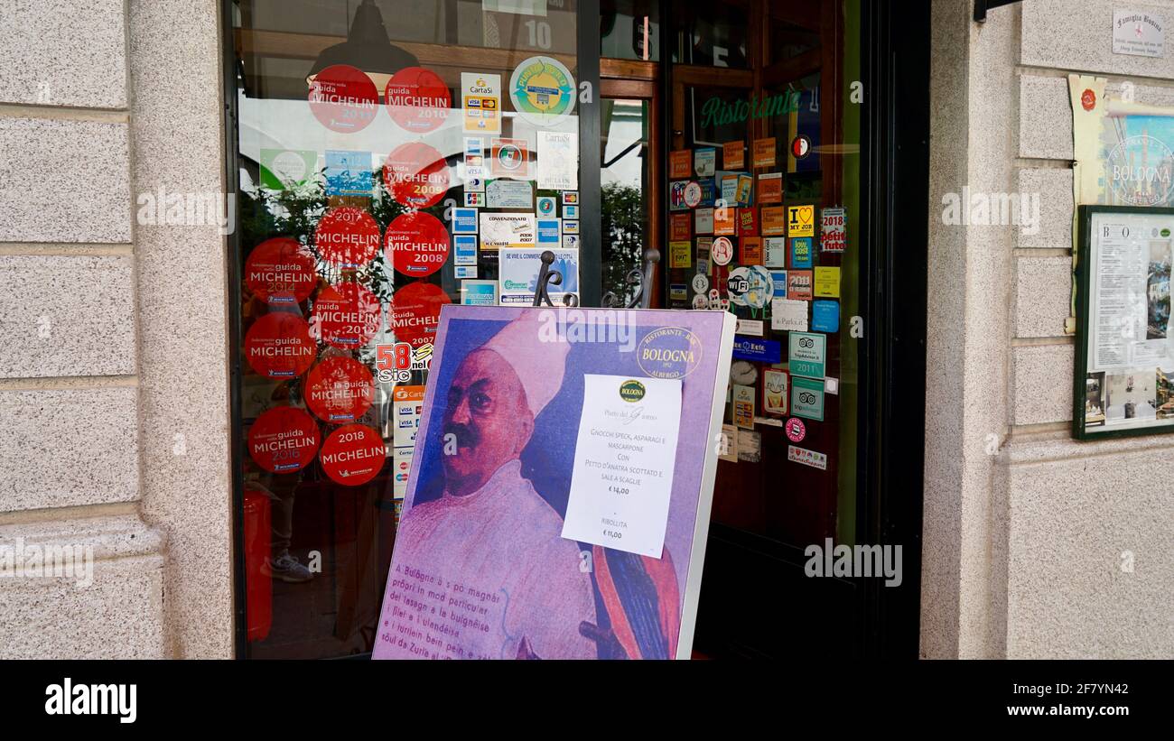 The front door of Michelin restaurant in Varese with lots of stickers ...