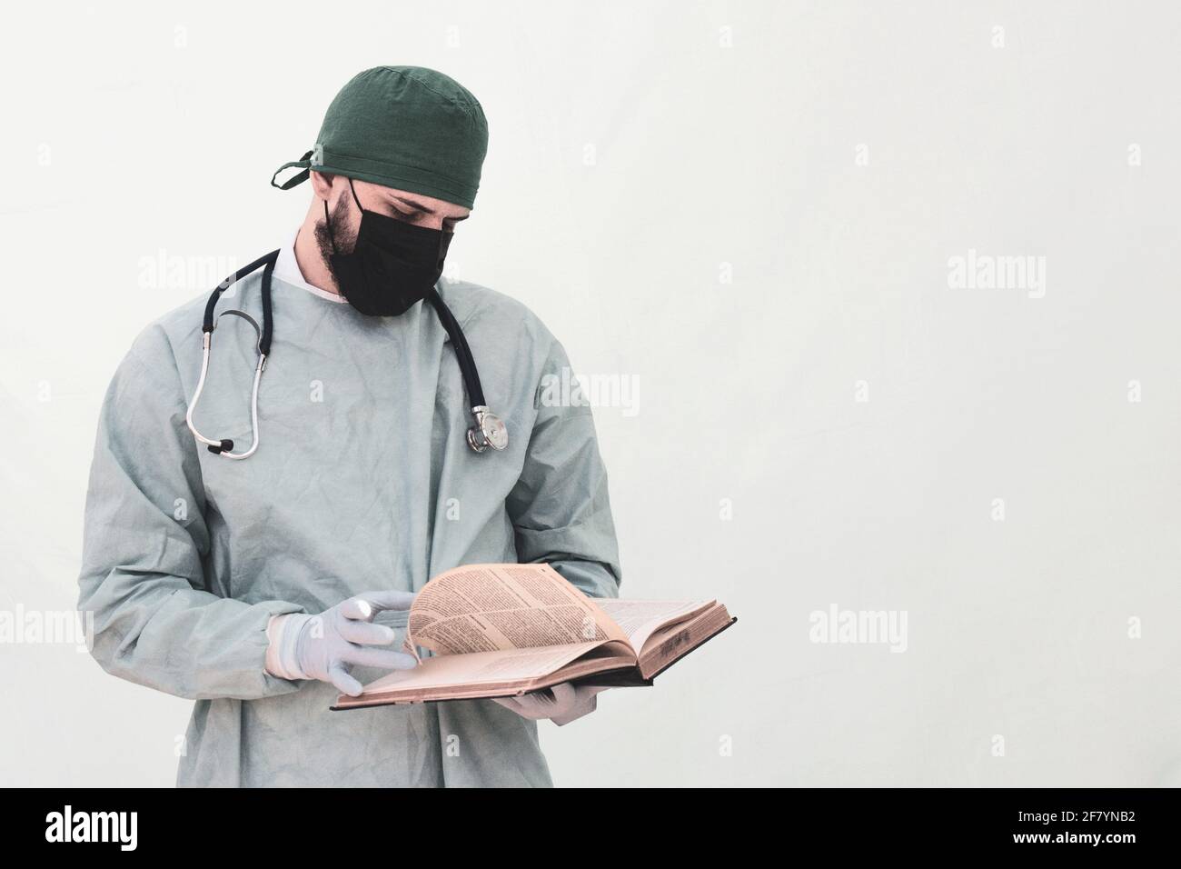 Male doctor reading up before a surgery Stock Photo - Alamy