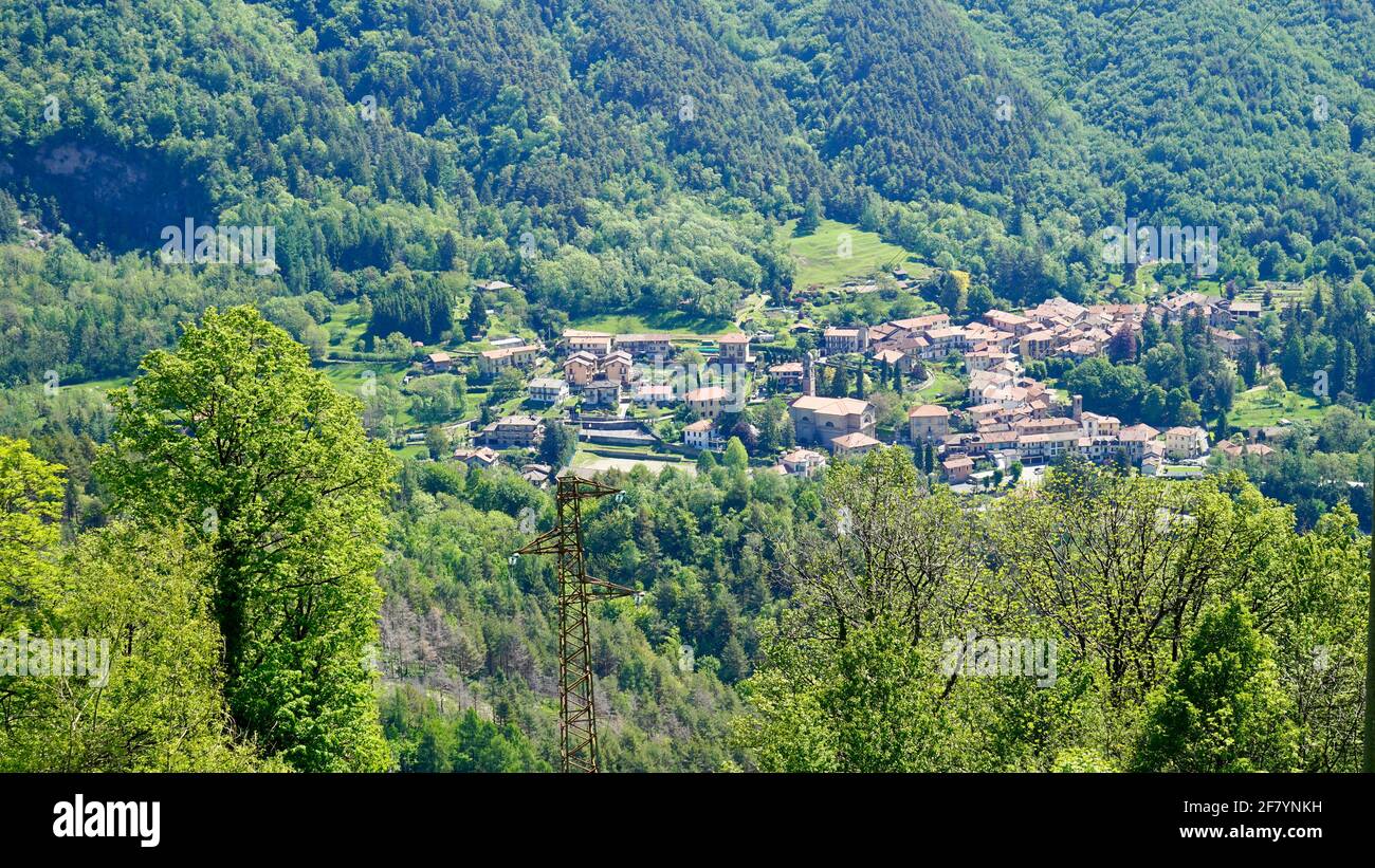 Green mountain of Sacro Monte with small town in a sunny day with blue ...