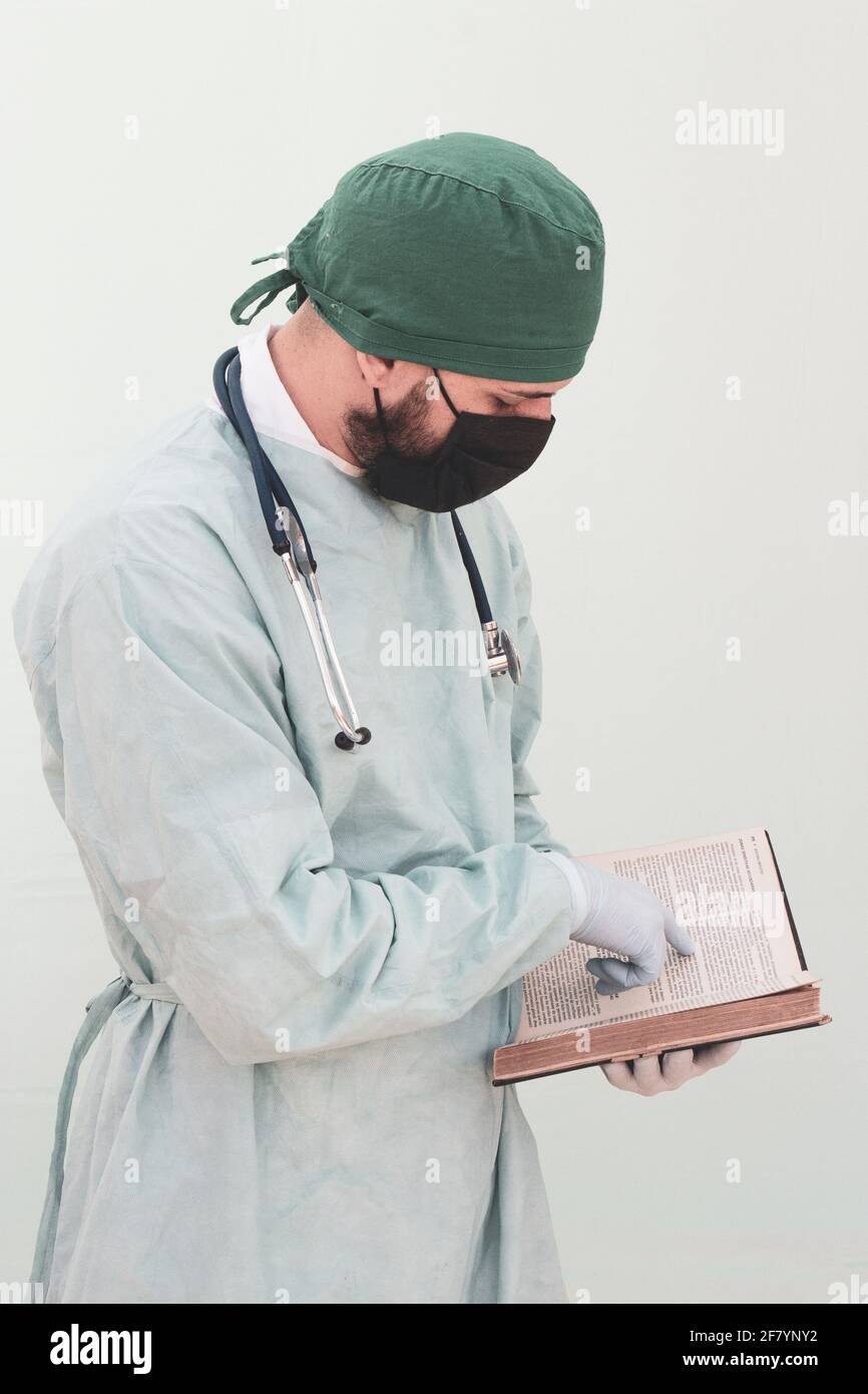 Vertical shot of a male doctor reading up before a surgery Stock Photo ...