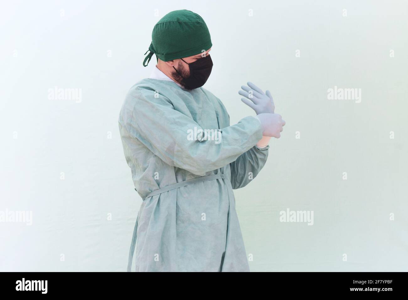 Male doctor preparing for surgery isolated on a white background Stock ...