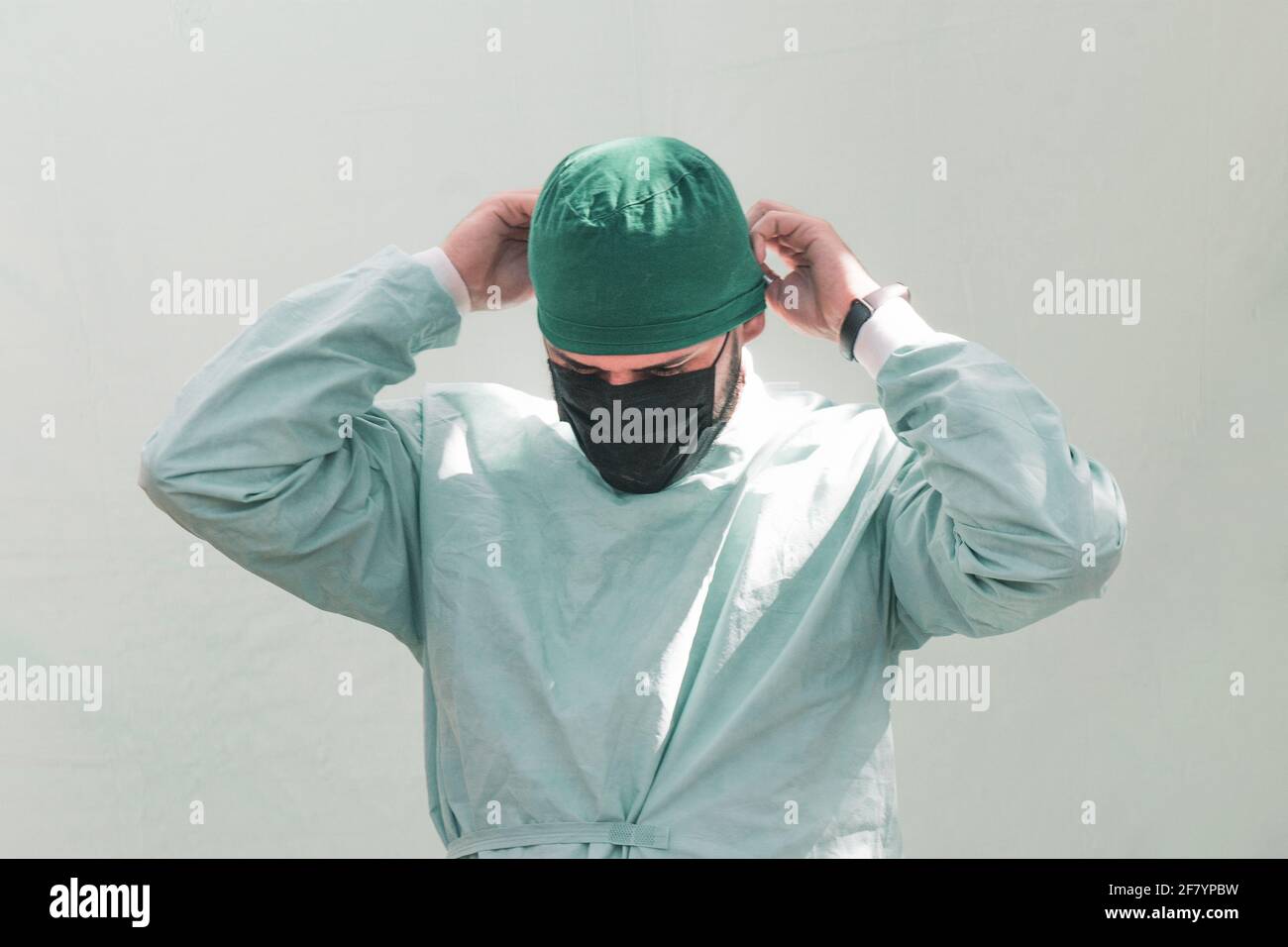 Male doctor preparing for surgery isolated on a white background Stock ...