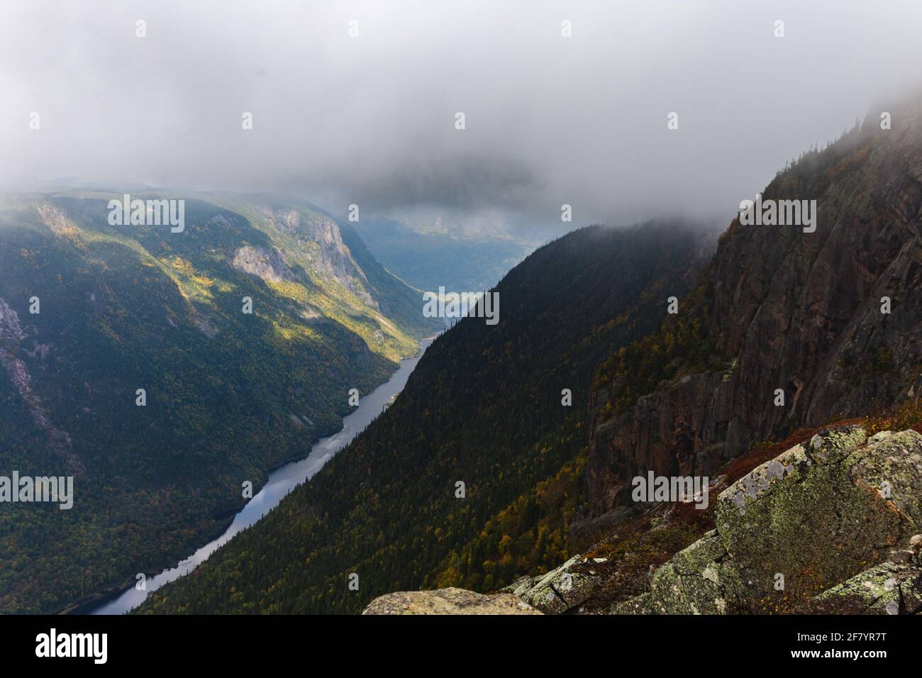 view from the top of a cliff in summer with a river in the valley Stock ...