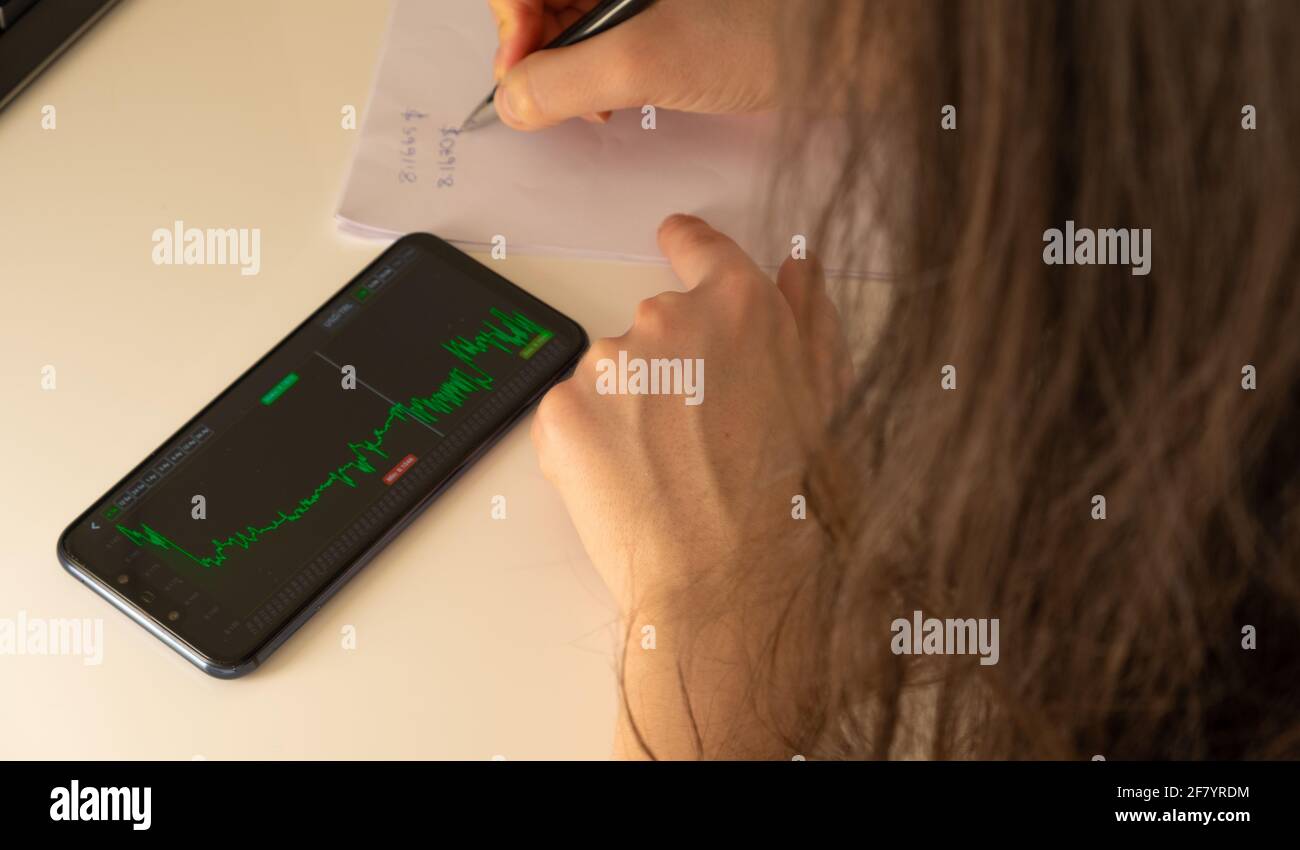 woman doing financial analysis and taking notes Stock Photo - Alamy