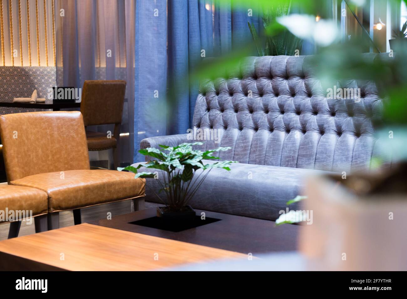 Bar with a nice leather couch and chairs around a wooden table with ...