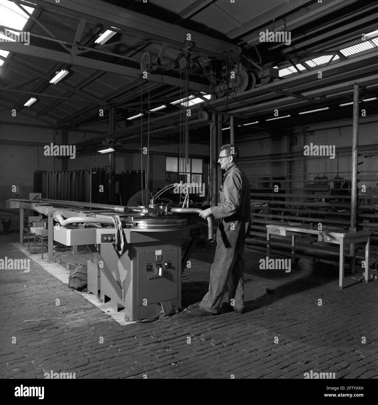 Machine bench worker engaged in machining pipes at the Rijkswerf (RW ...