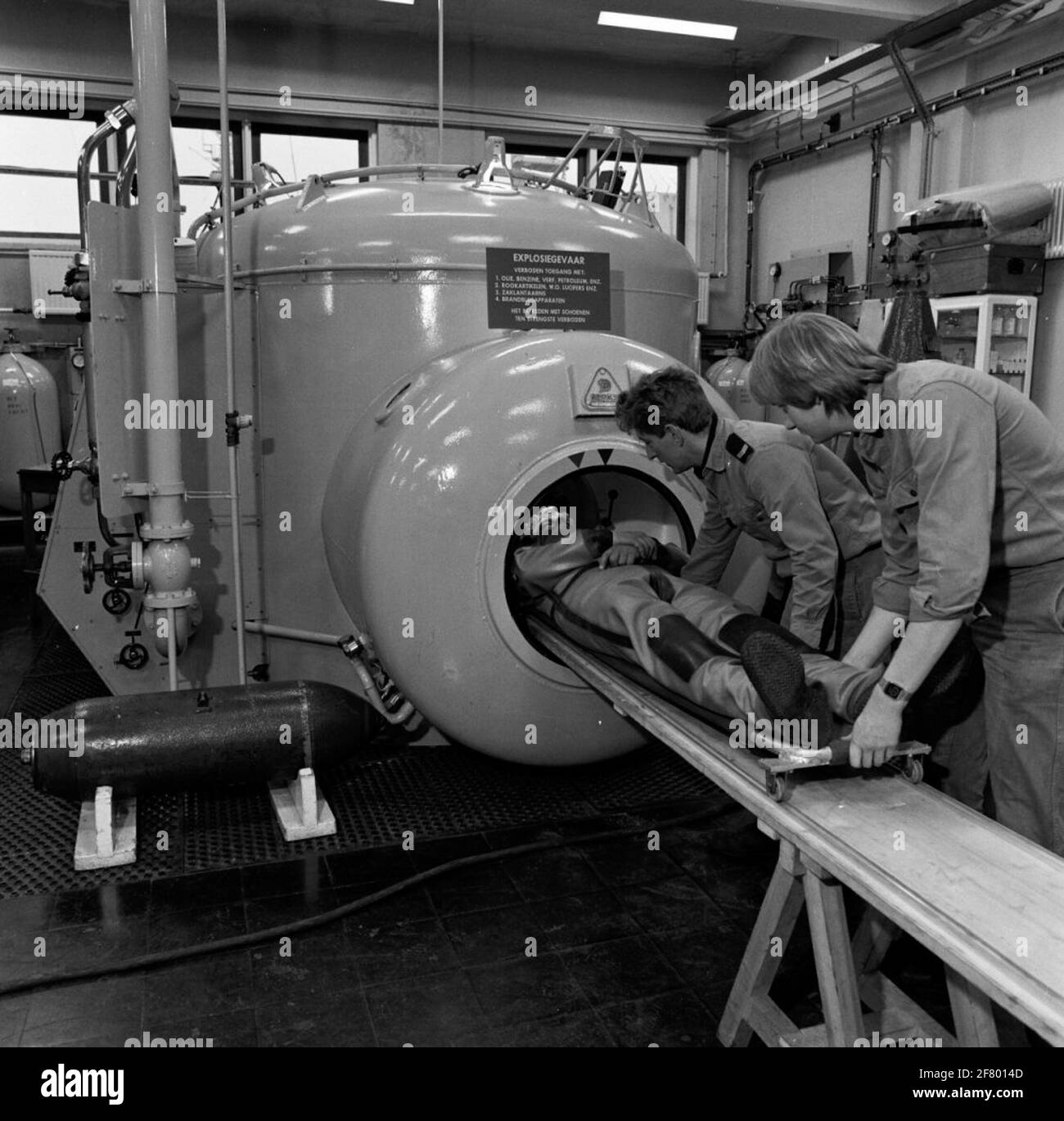 A diver is placed in a decompression tank by staff of the German ...