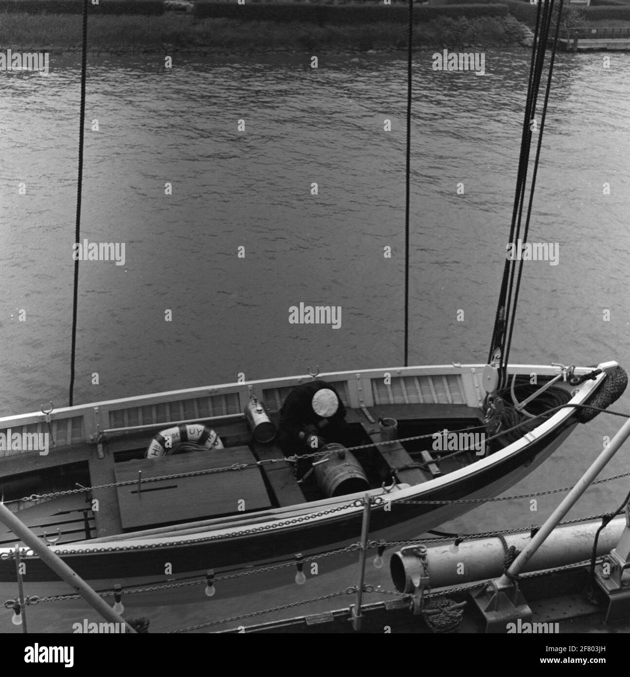 A sloop of cruiser Hr.Ms. De Ruyter (C 801) hangs in Davits, 1955 Stock ...