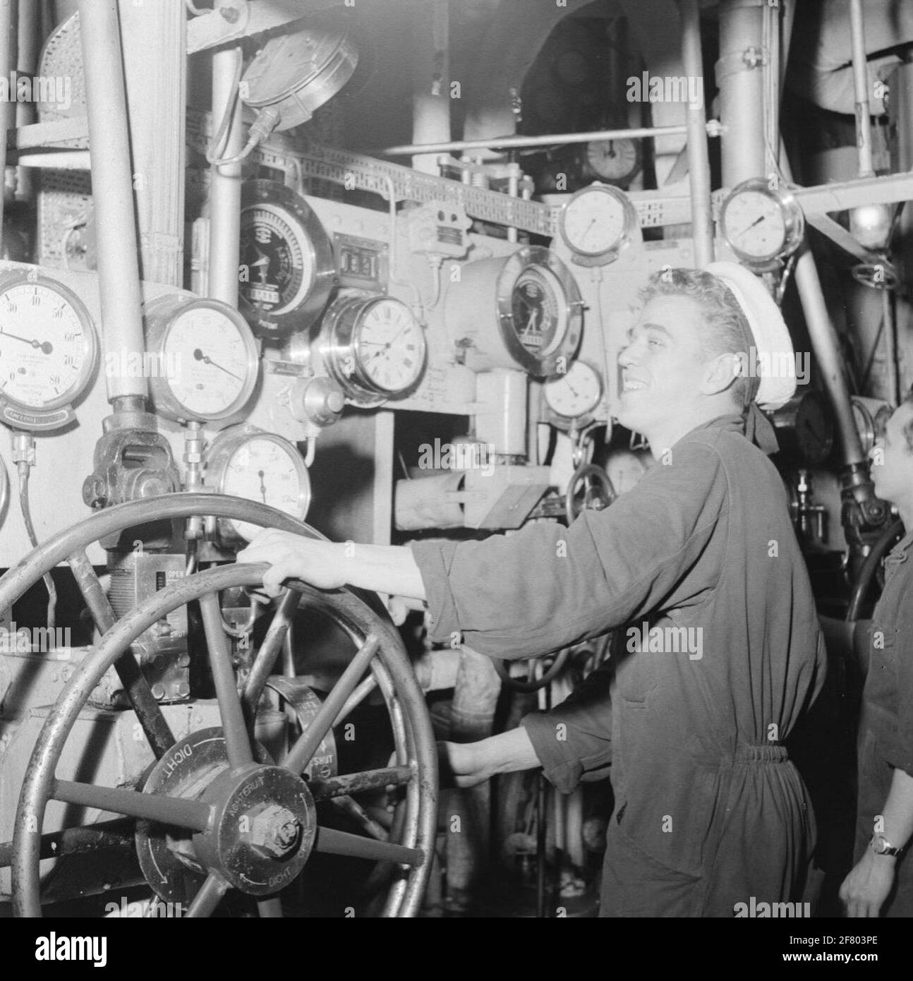 A driver in the engine room of the torpedo boat hunter Hr.Ms. Evertsen ...
