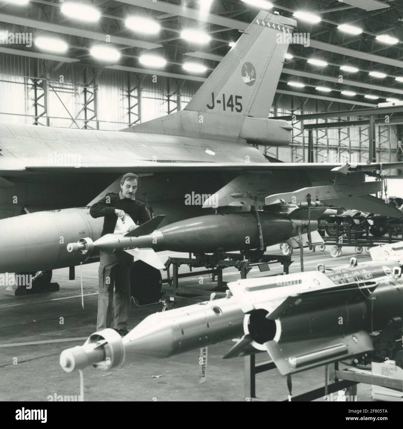 A GBU Paveway II led bomb to a general Dynamics F-16AM pylon with ...