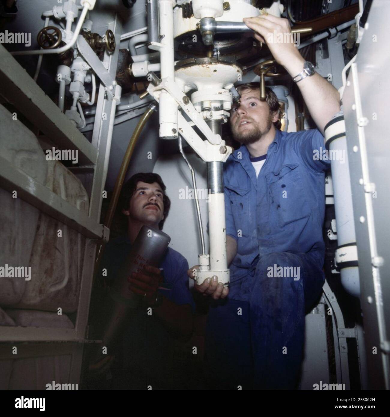 Two crew members in the periscope room in a submarine, possibly hr.ms ...