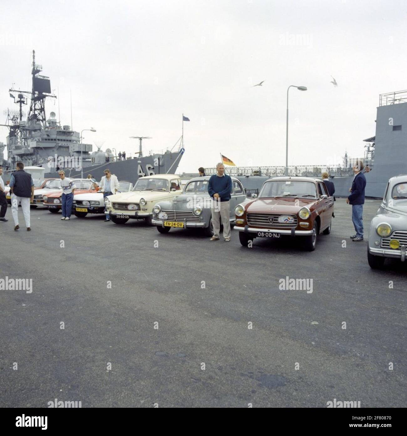 Oldtimers on the quay arranged with frigates and destroyers in the ...