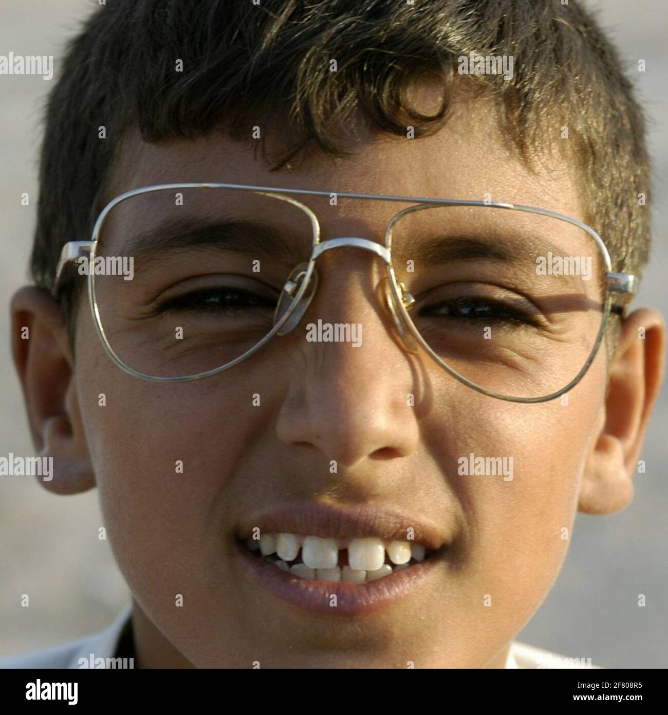 Iraqi boy with glasses Stock Photo - Alamy