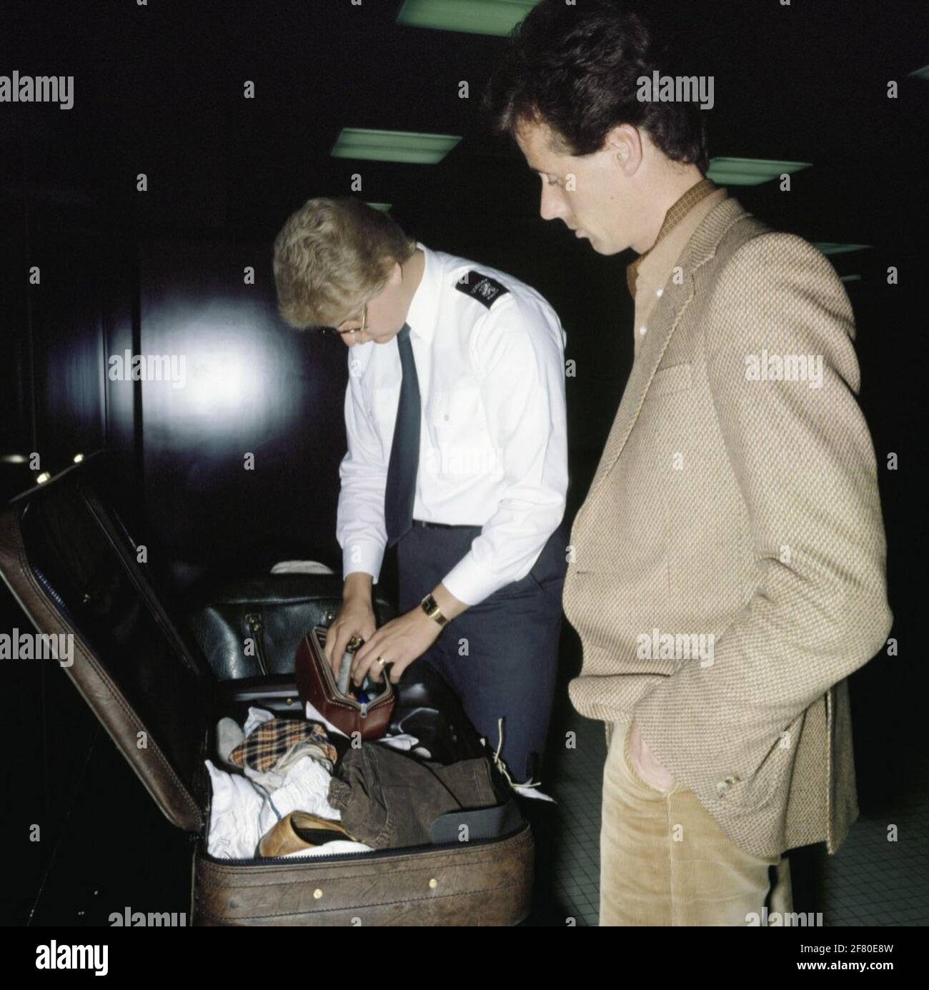 Checking the luggage by a customs officer at Schiphol Airport Stock ...