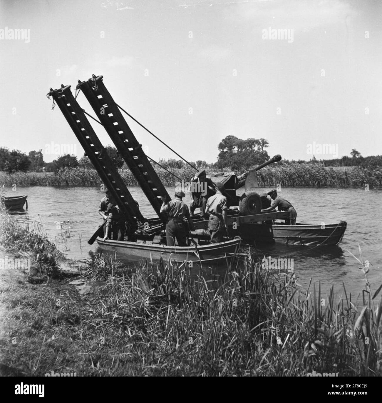 Pontonniers transport a 6-ponder anti-tank guns on a folding boat raft ...