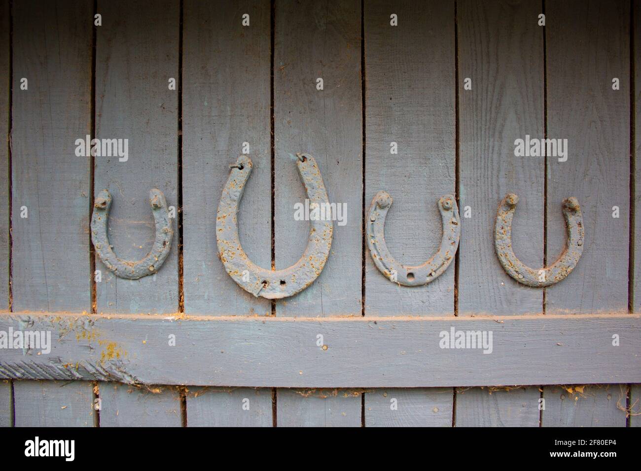 Good luck symbol. Set of old rusty horseshoes on a wooden background ...