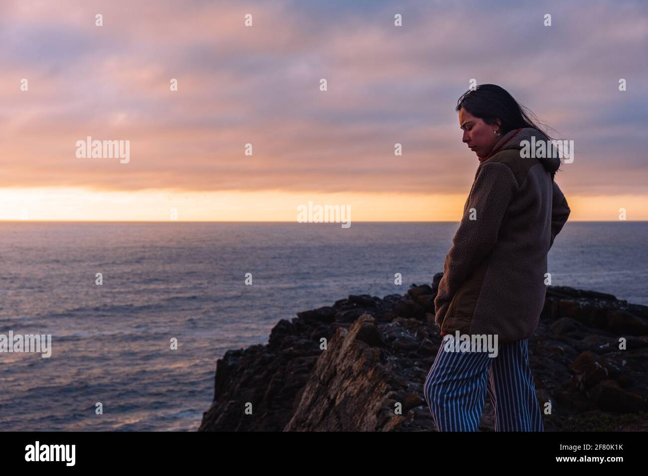 Woman looking sunset beach hi-res stock photography and images - Alamy