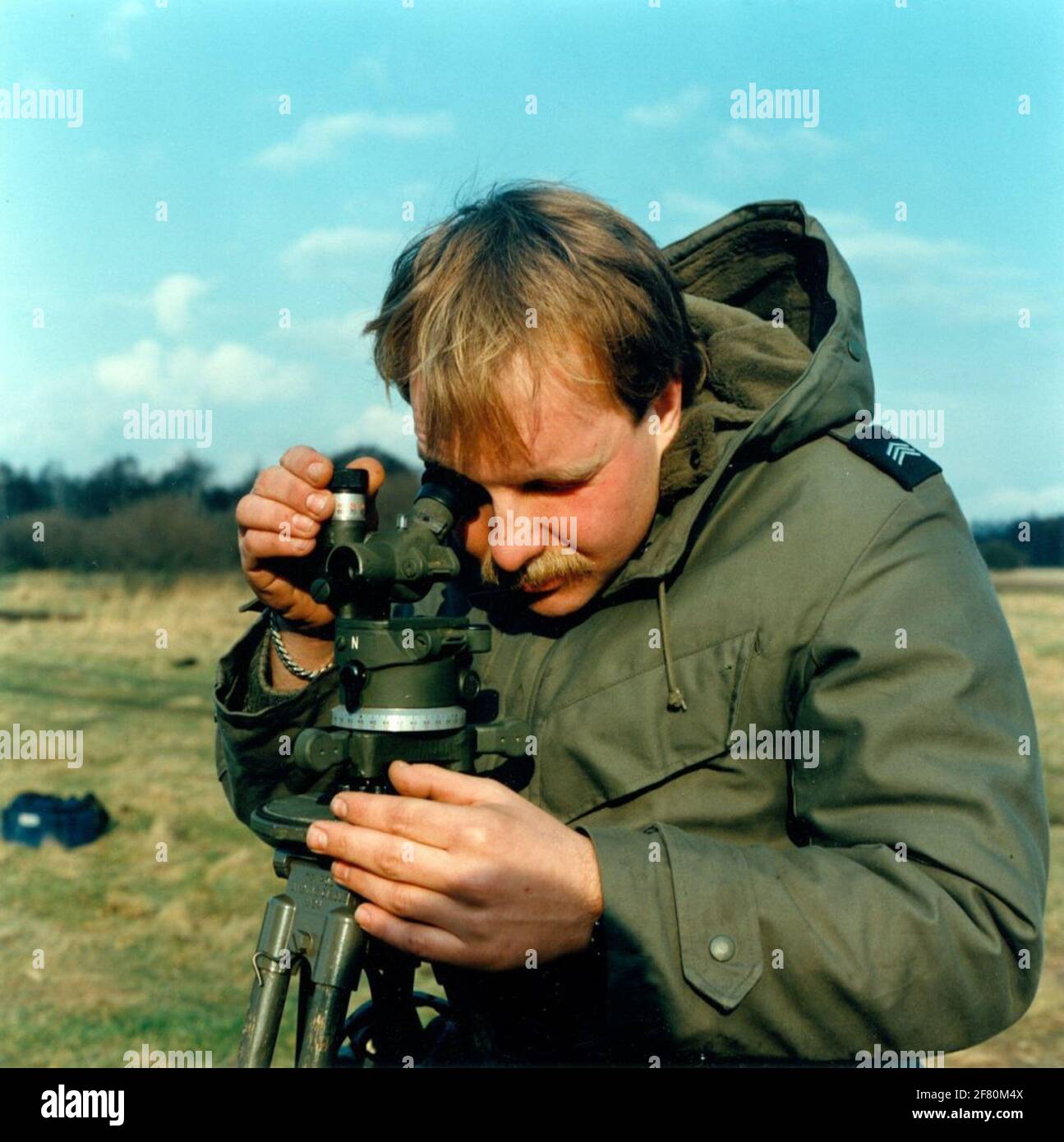 A sergeant is engaged in aligning led weapon equipment using an M-2 ...