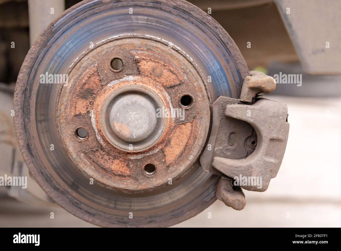 Heavily worn brake disc. Car brake disc after removing the wheel. A ...