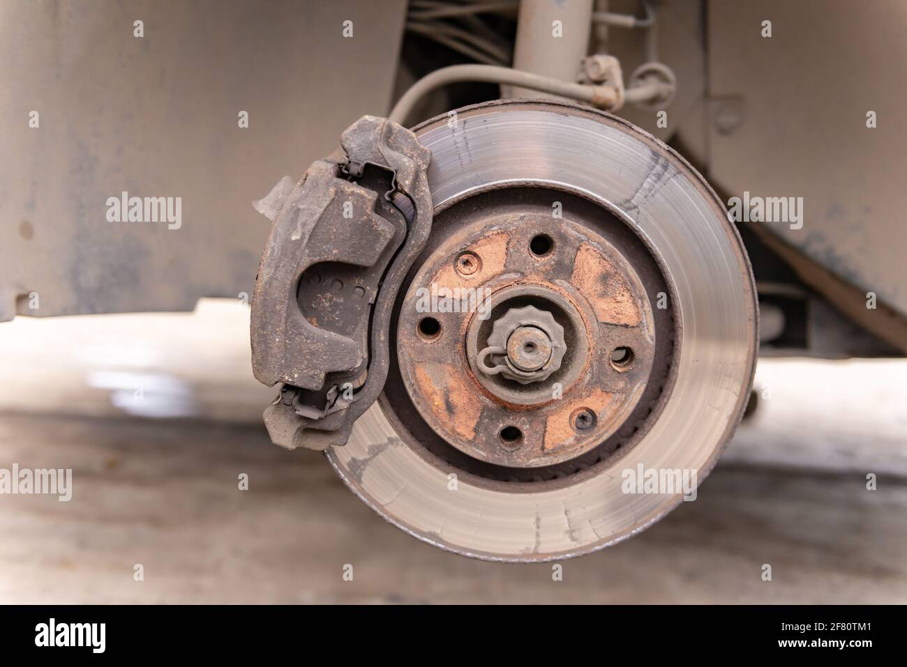 Heavily worn brake disc. Car brake disc after removing the wheel. A ...