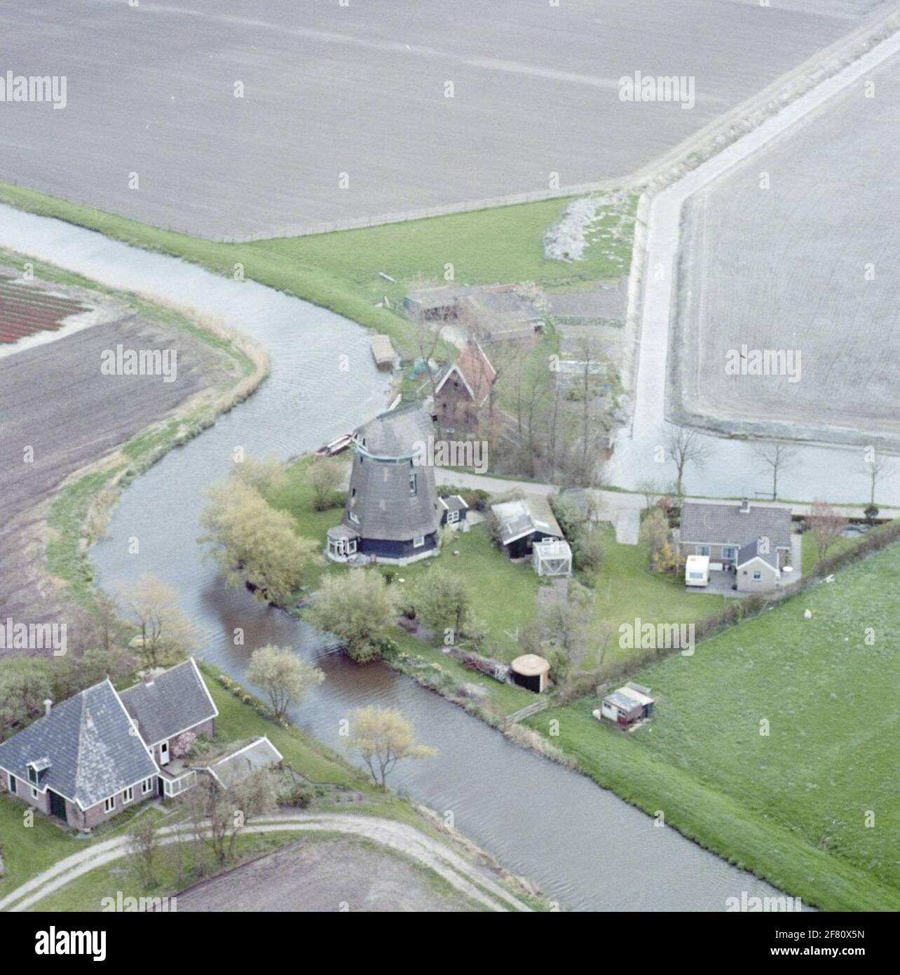Aerial view of a farm, a mill without blades and a pumping station ...