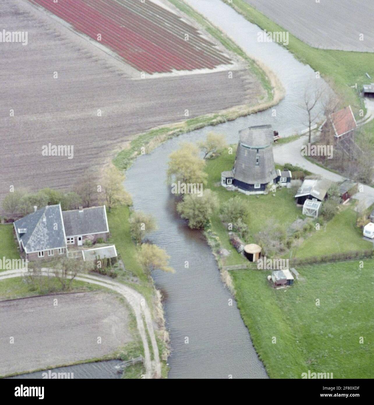 Aerial view of a farm, a mill without blades and a pumping station ...