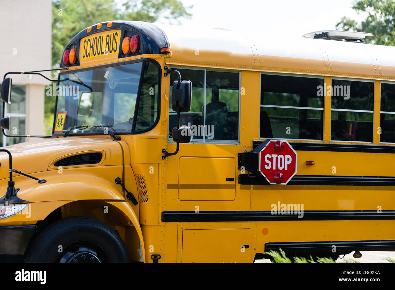 Yellow school bus on the street Stock Photo - Alamy