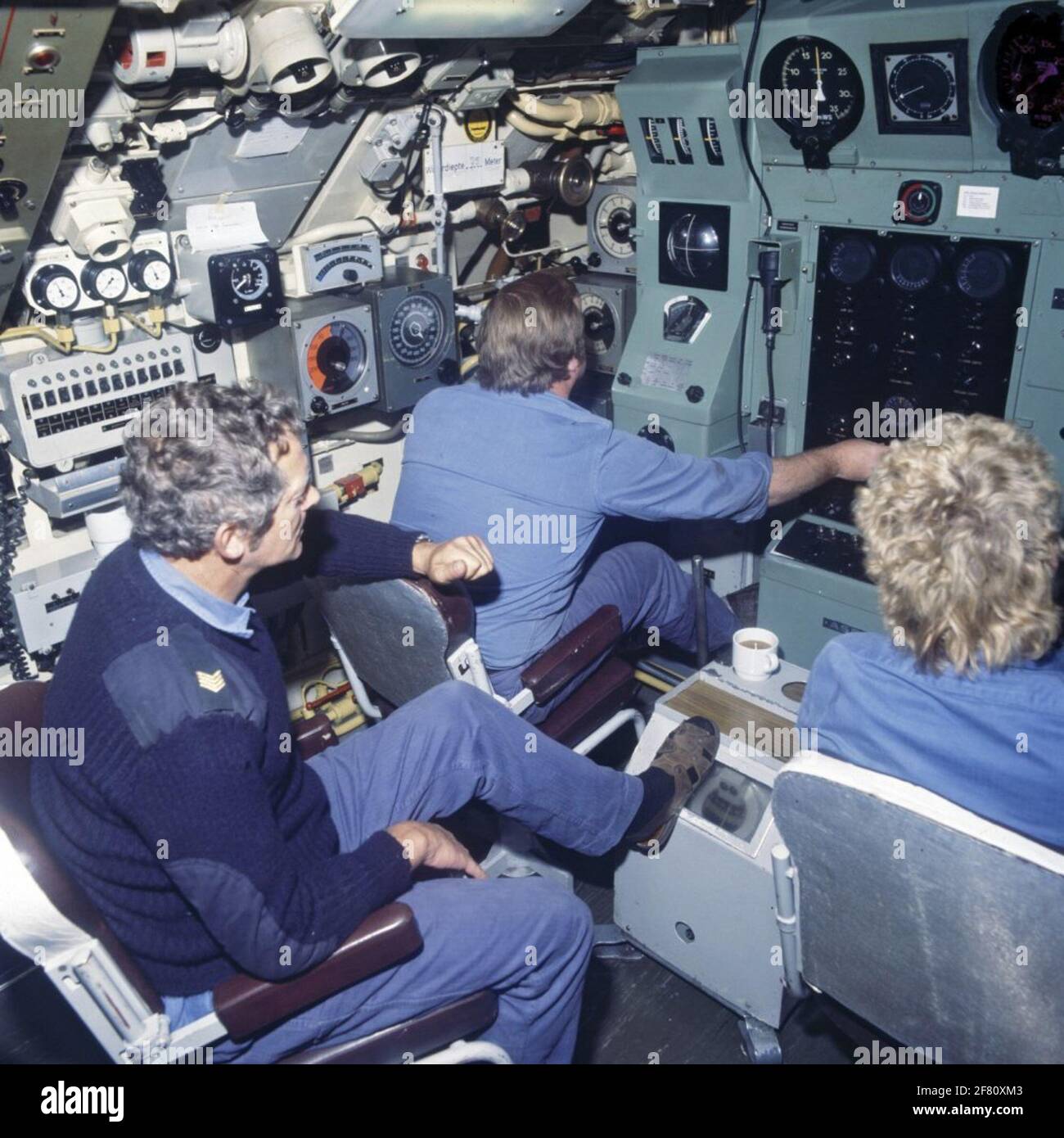 Three crew members in the central of the submarine Hr.Ms. Tiger shark ...