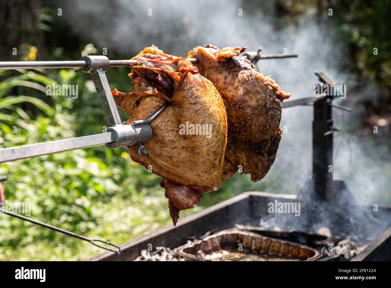 meat pieces rolling over a fire outdoor cooking with smoke Stock Photo ...