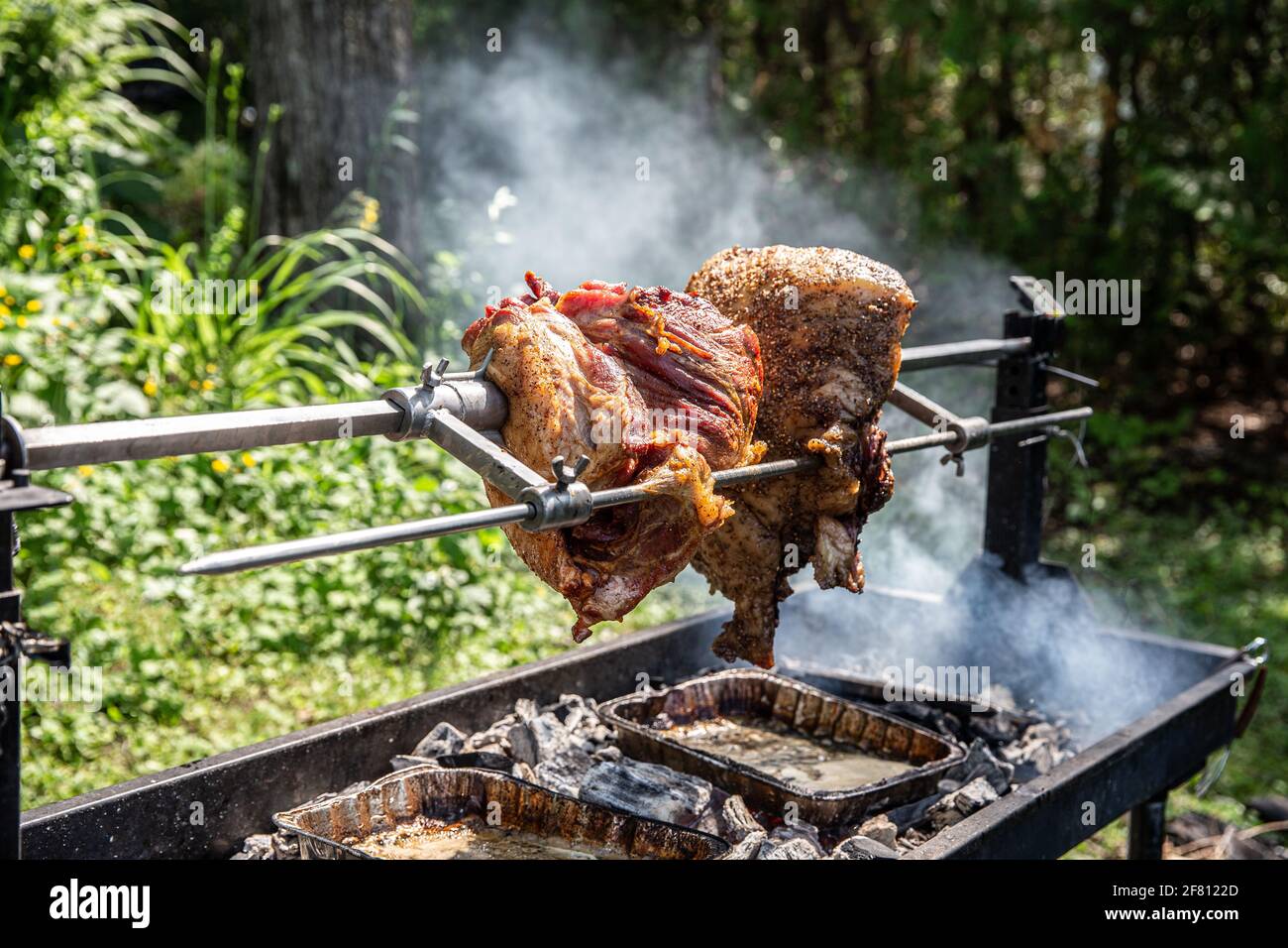 meat pieces rolling over a fire outdoor with smoke Stock Photo - Alamy