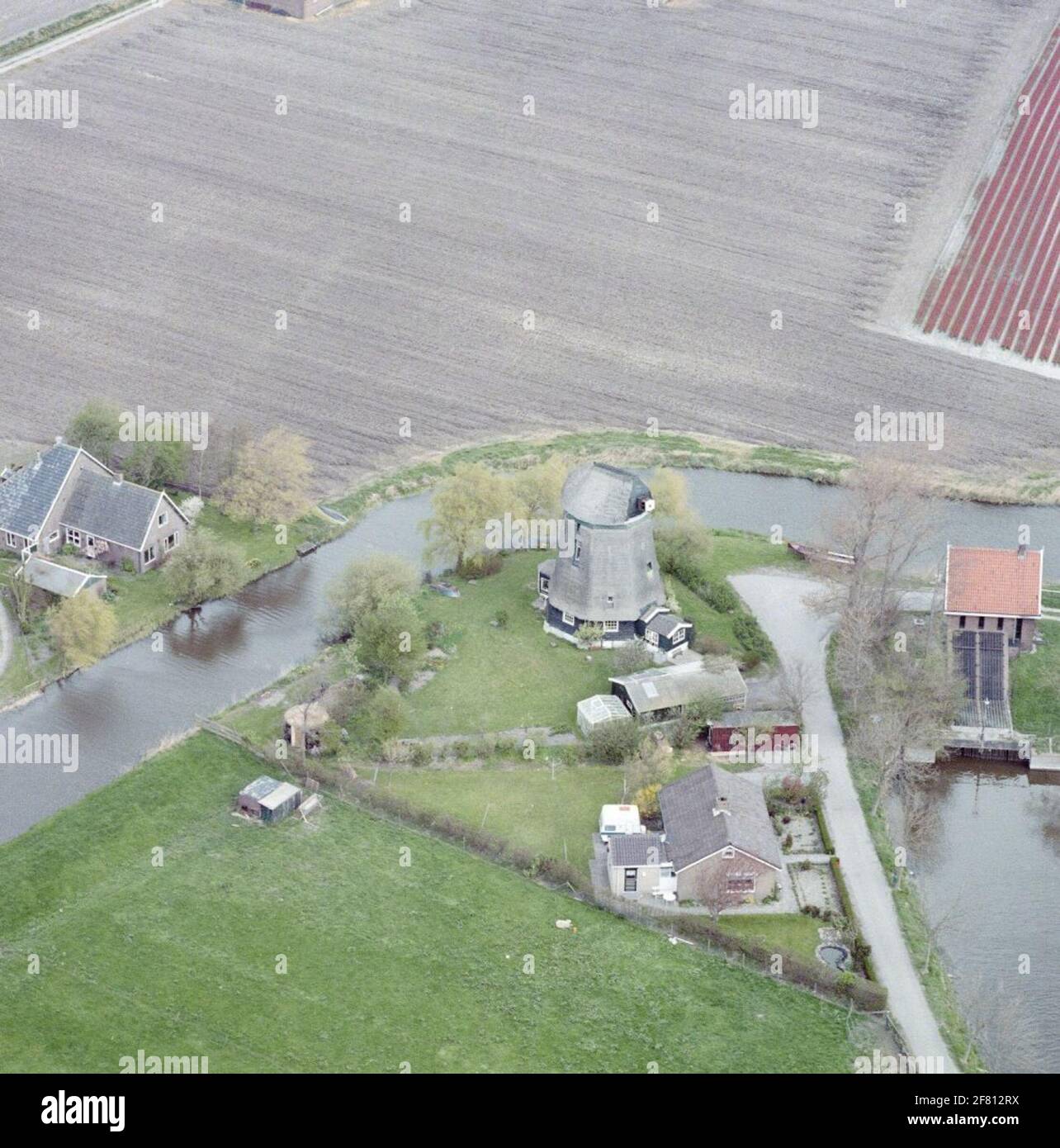 Aerial view of a farm, a mill without blades and a pumping station ...