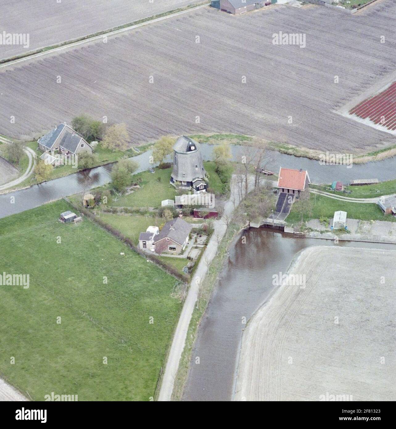 Aerial view of a farm, a mill without blades and a pumping station ...