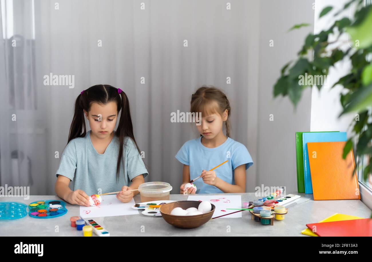 two little girls with brush painting on table, education, watercolor ...