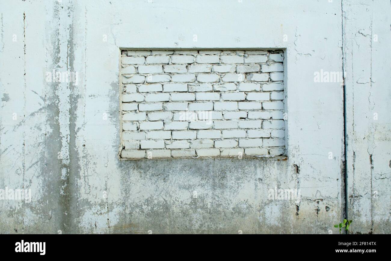 Square hole in the concrete wall with bricked-in. The background of the ...