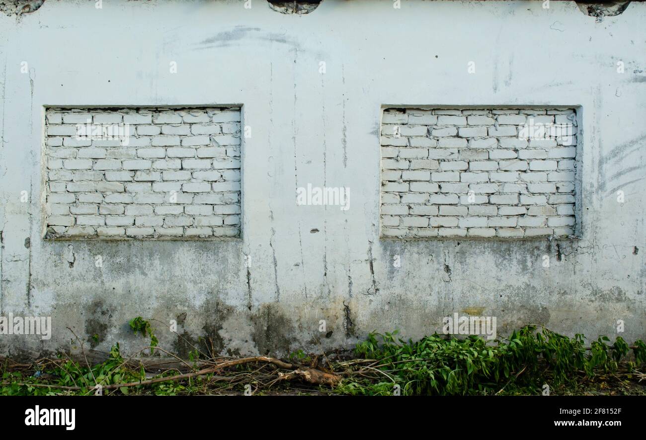 Square hole in the concrete wall with bricked-in. The background of the ...