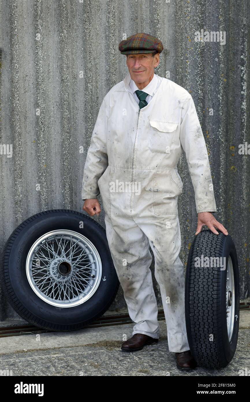 Mechanic working on a tyre and wheel at Goodwood Revival, West Sussex ...