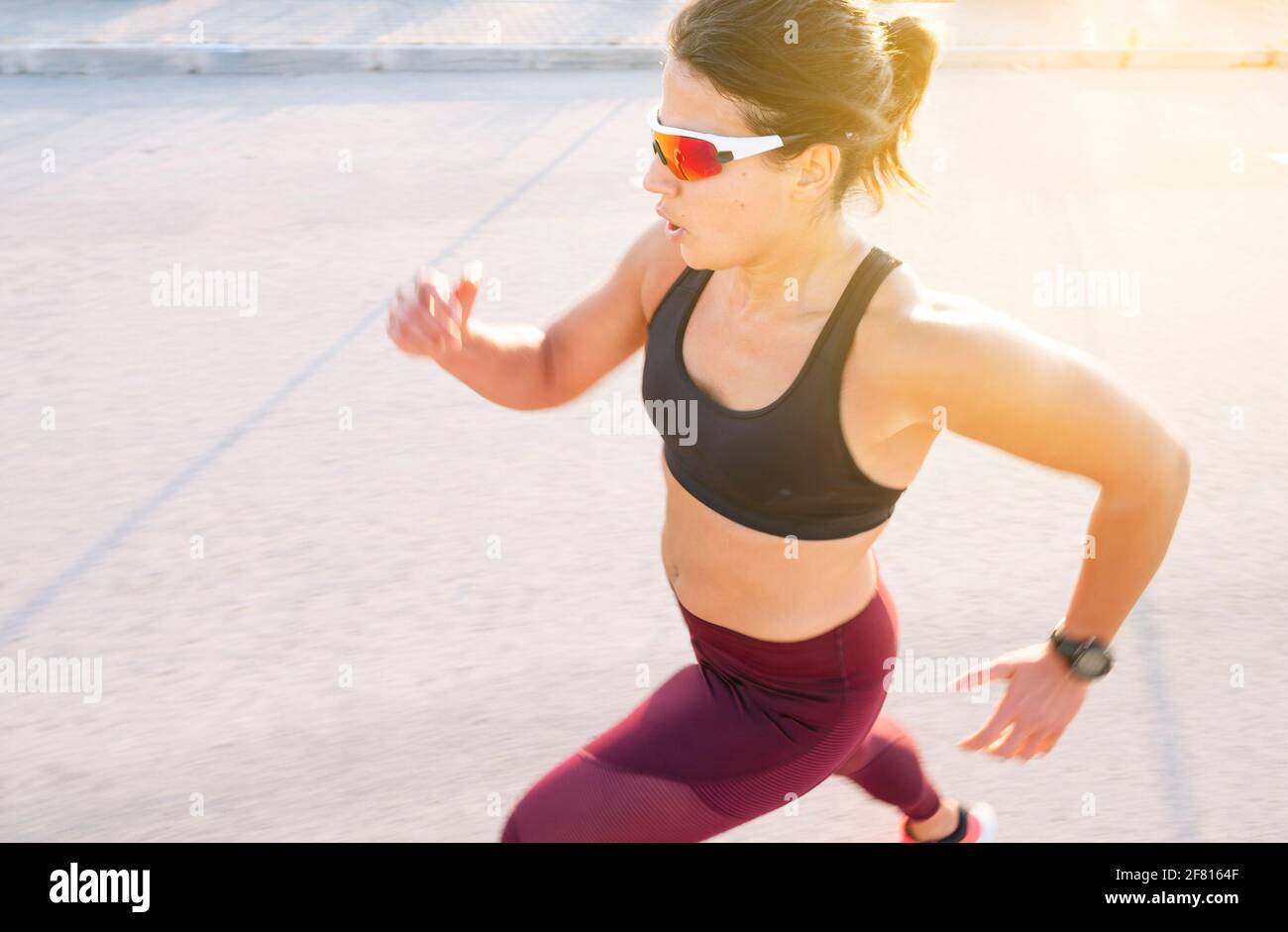 Athletic woman running in the street Stock Photo - Alamy