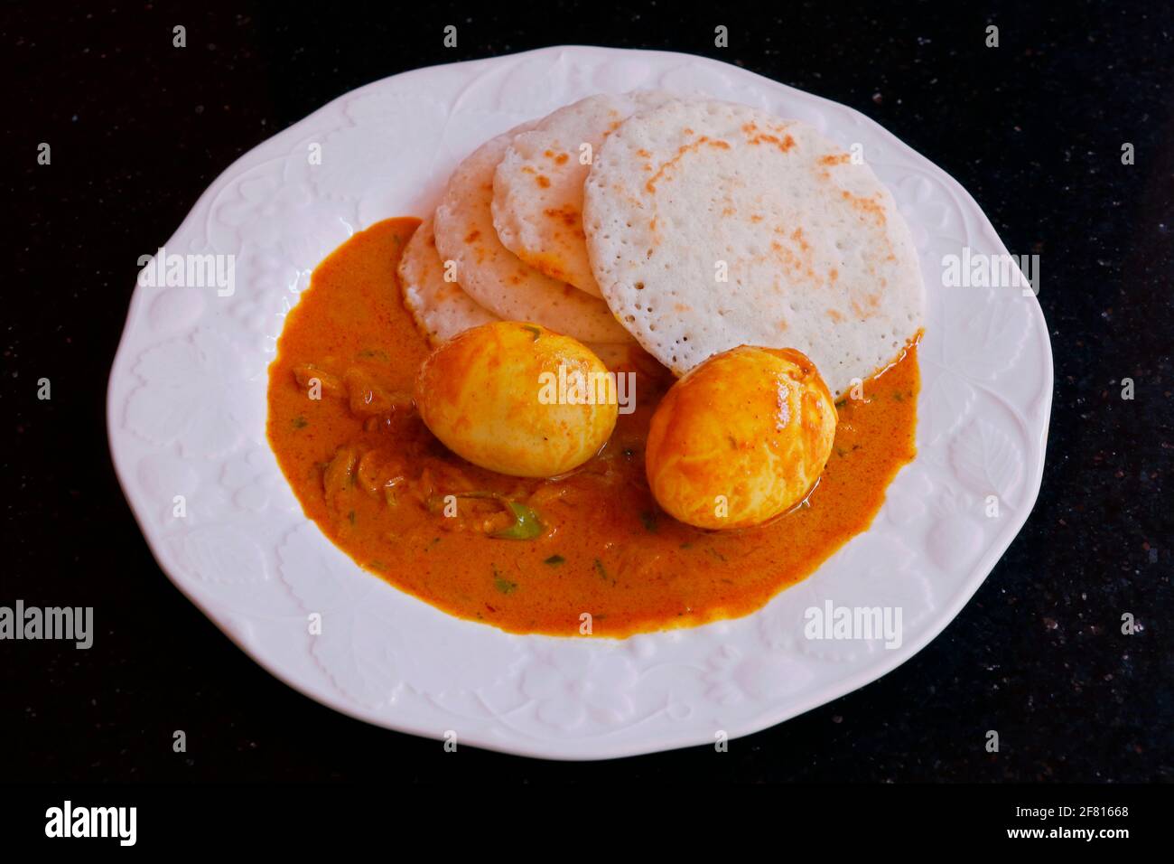 traditional kerala style breakfast rice cake known as appam with egg ...
