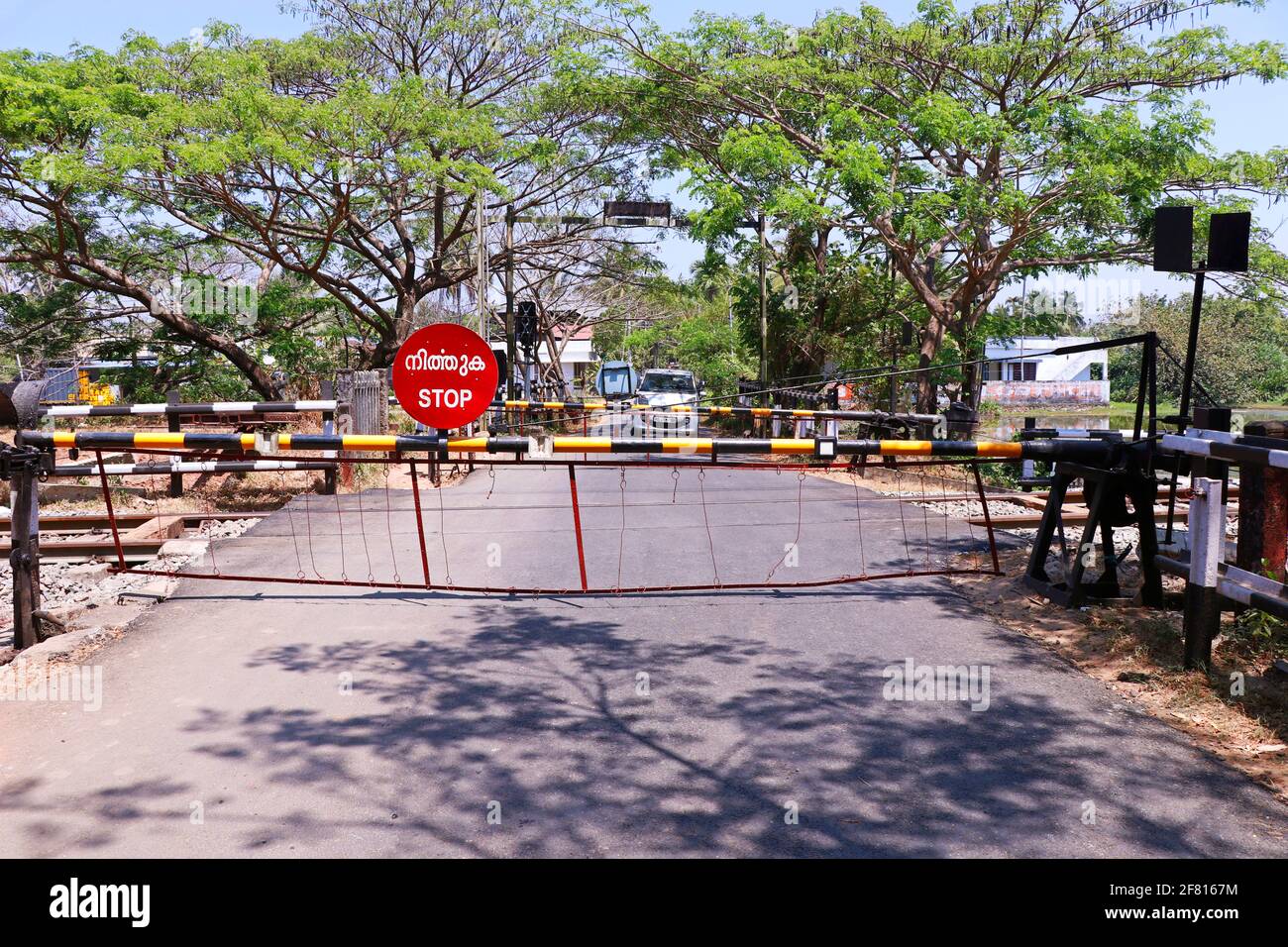 indian railway level crossing gates with stop board Stock Photo - Alamy