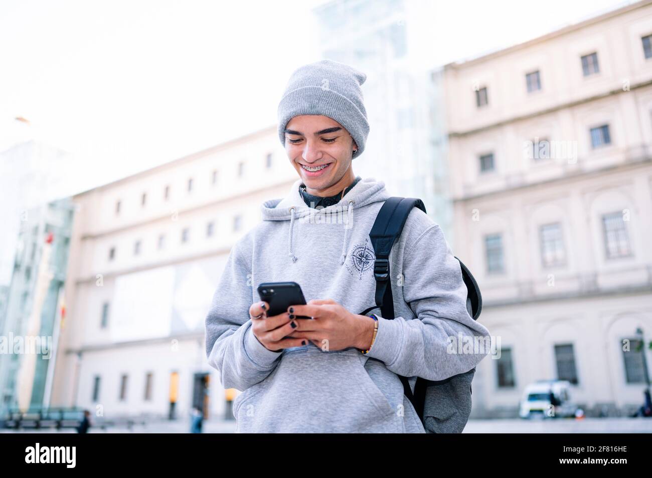 Profile of a happy guy using a smart phone Stock Photo - Alamy
