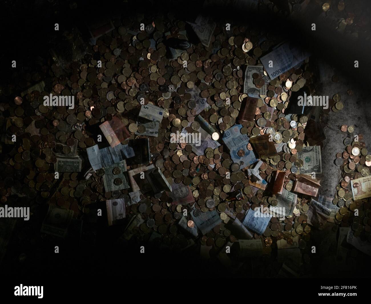 Collection of different coins currencies money thrown into well for ...