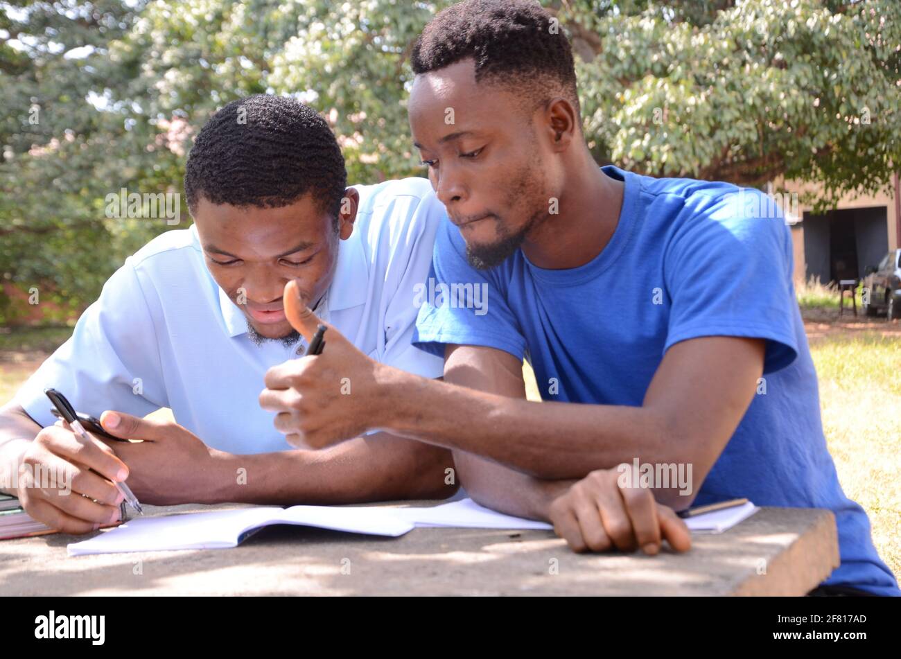 Shallow focus shot of two African men studying Stock Photo - Alamy