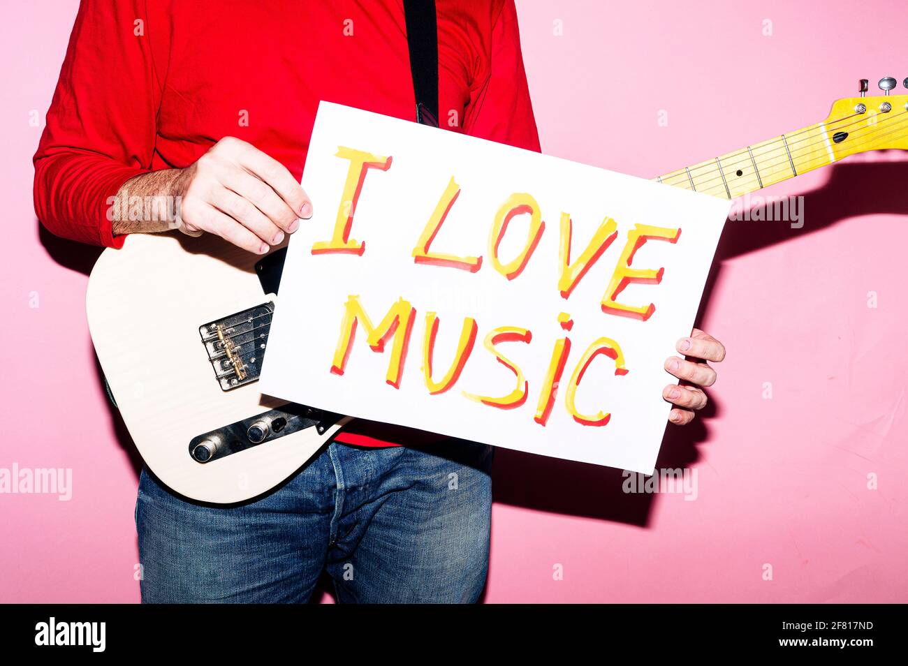 Musician man with guitar and sign that says I love music Stock Photo ...