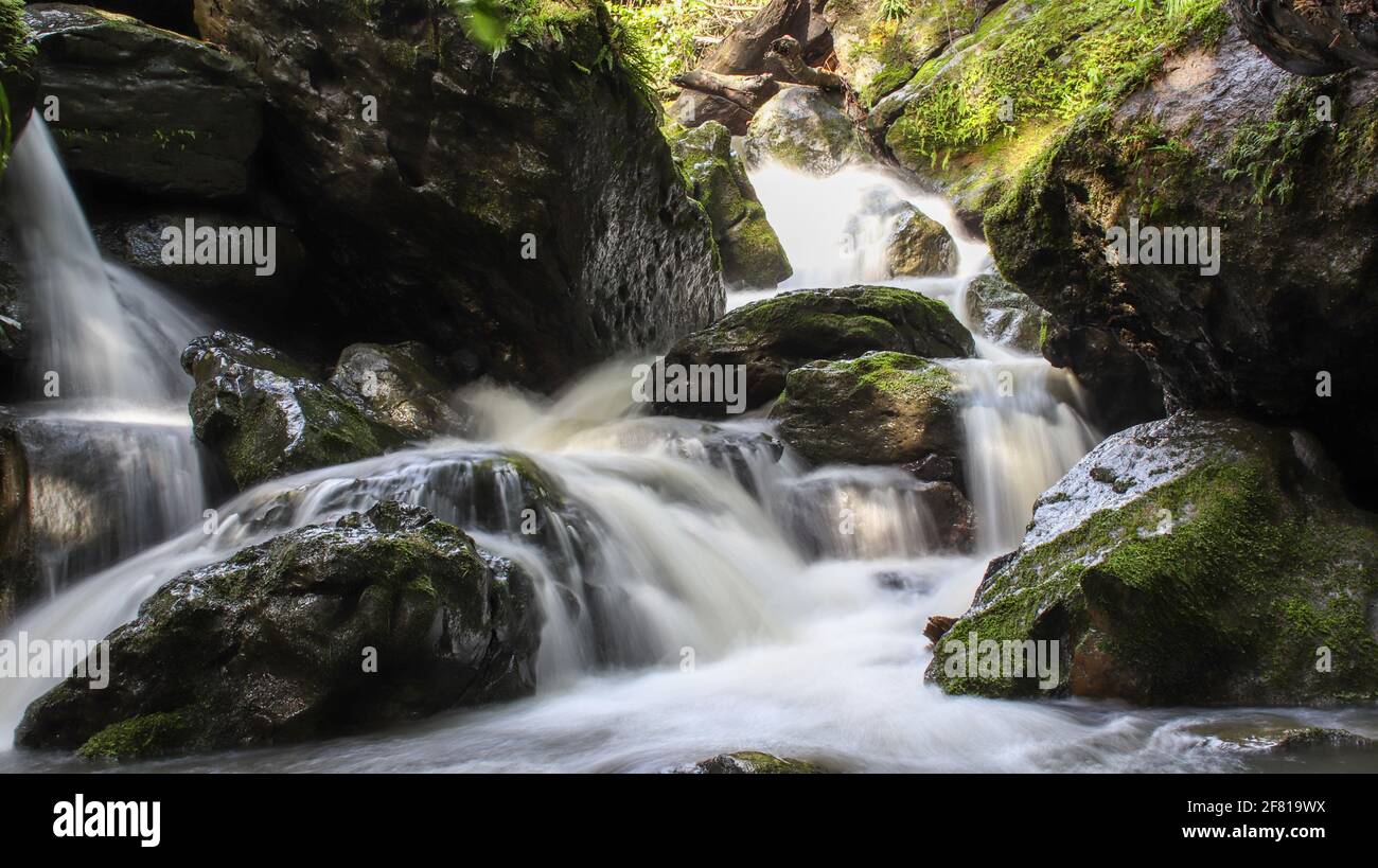 Closeup shot of cascades of fast-flowing streams on the mountain rocks ...