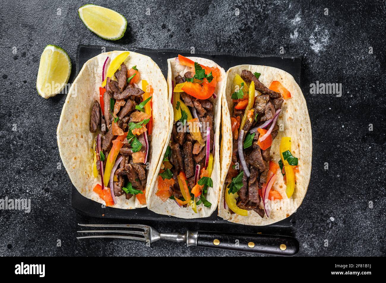 Mexican tacos shells with beef meat, onion, tomato and sweet pepper ...