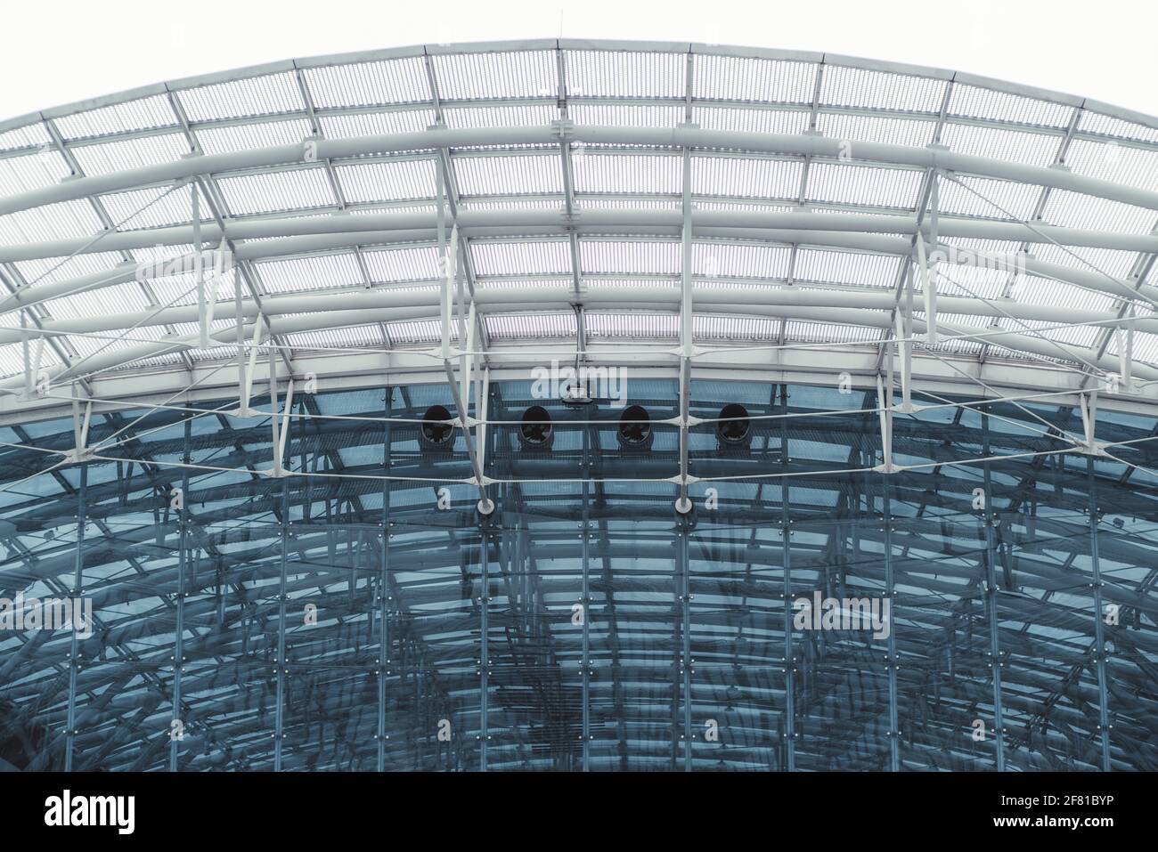 A bluish contemporary glass facade and the roof of a modern building ...
