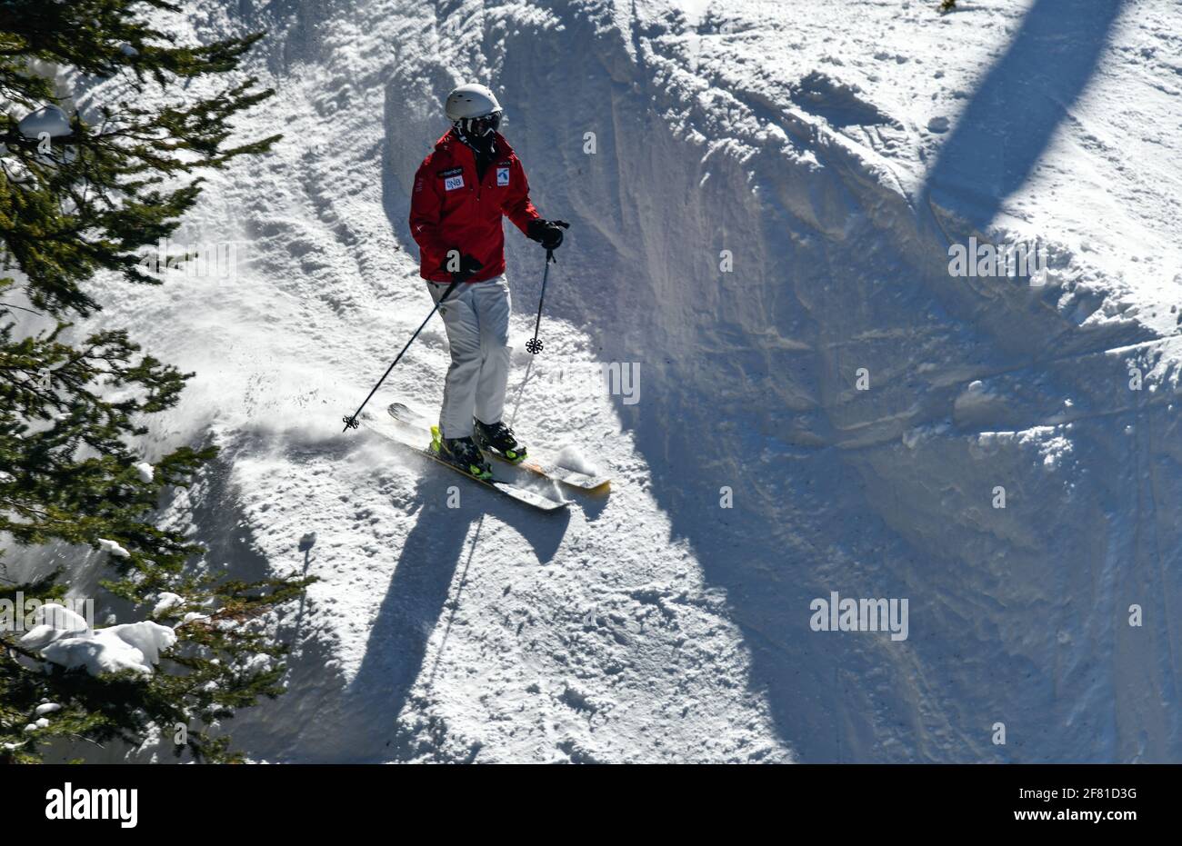 Skier going down the slopes on hi-speed at sunny day with fresh show at ...
