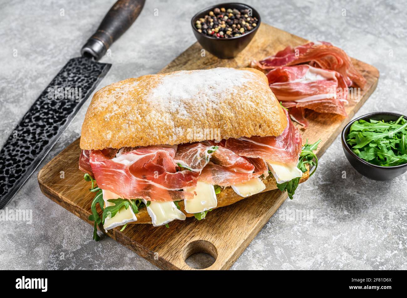 Ciabatta sandwich with prosciutto crudo ham, arugula and camembert brie ...