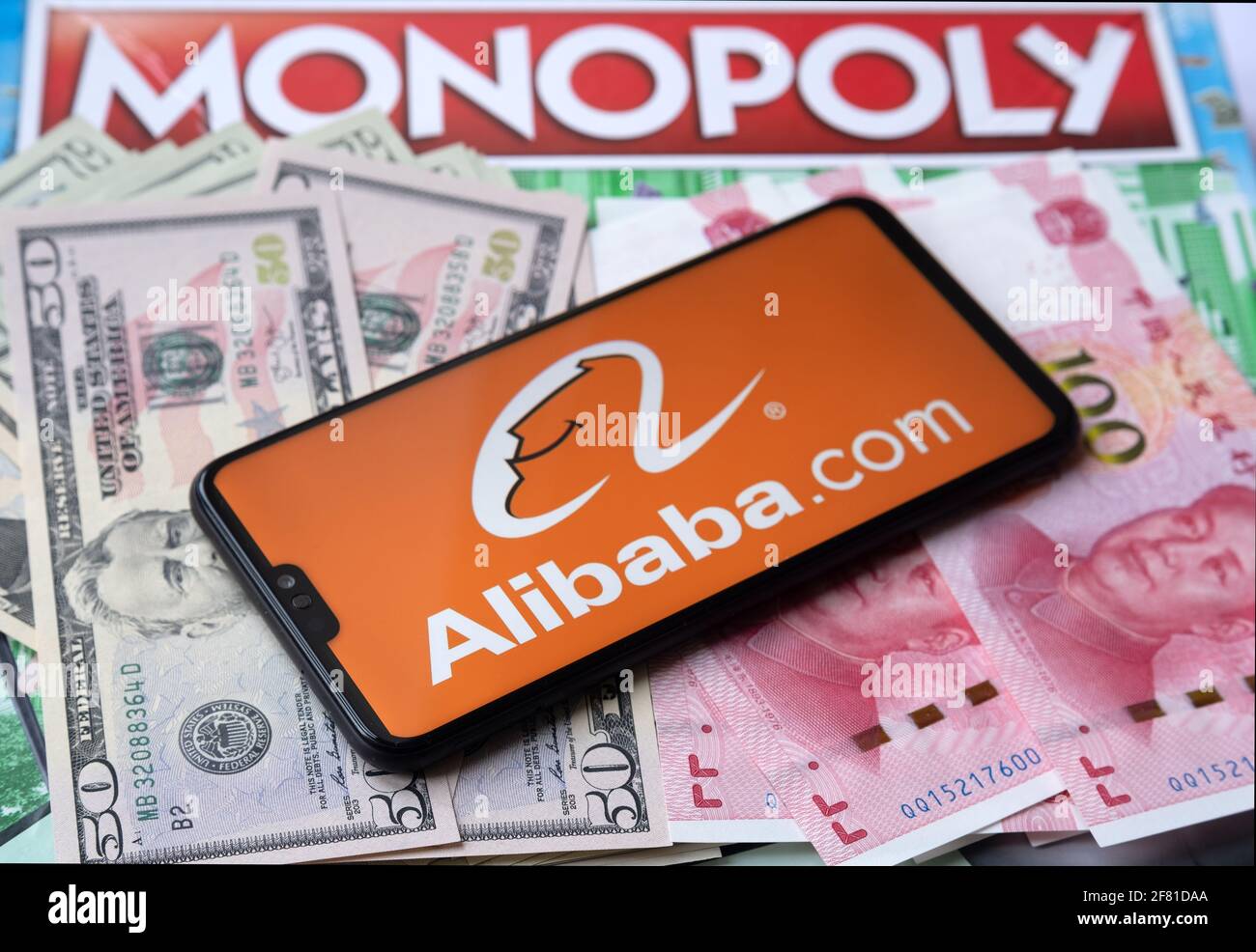 Alibaba logo seen on smartphone which is placed on money - US dollars ...